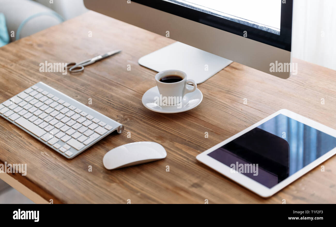 Office desk with computer, tablet and cup of coffee Stock Photo - Alamy