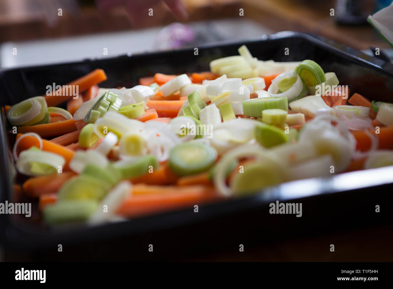 Baking tray full of raw chopped vegetables ready to cook Stock Photo ...