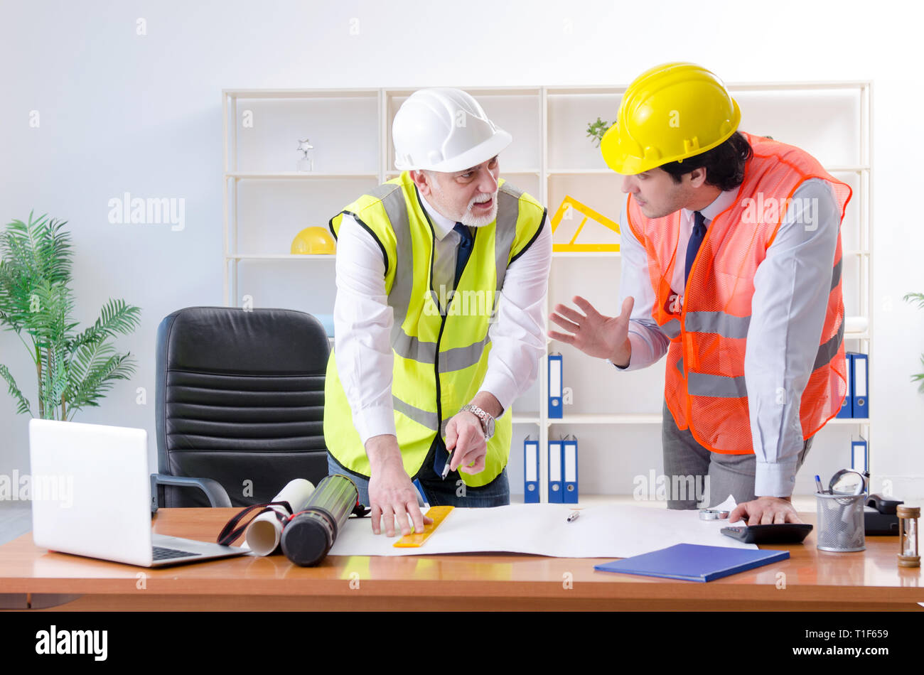 Two engineers colleagues working under project Stock Photo - Alamy