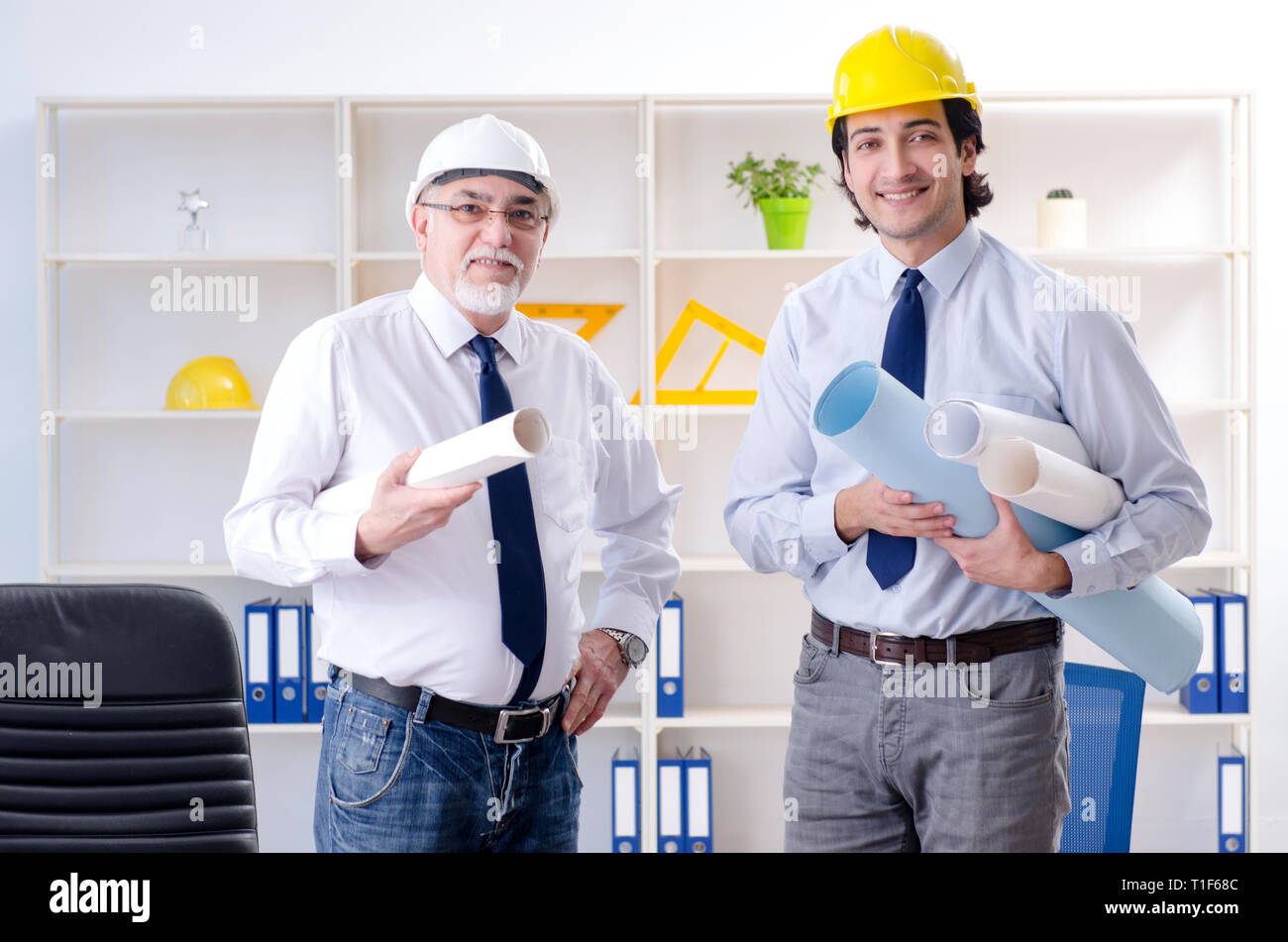 Two engineers colleagues working under project Stock Photo - Alamy