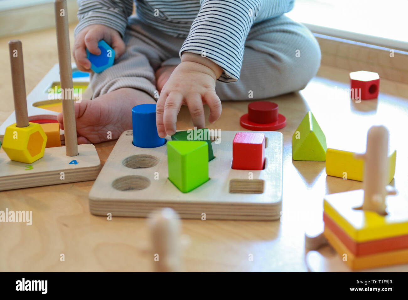 baby playing with colorful wooden blocks Stock Photo - Alamy