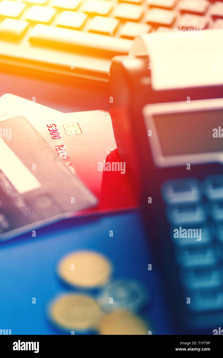 Modern payment terminal and credit cards near keyboard Stock Photo - Alamy