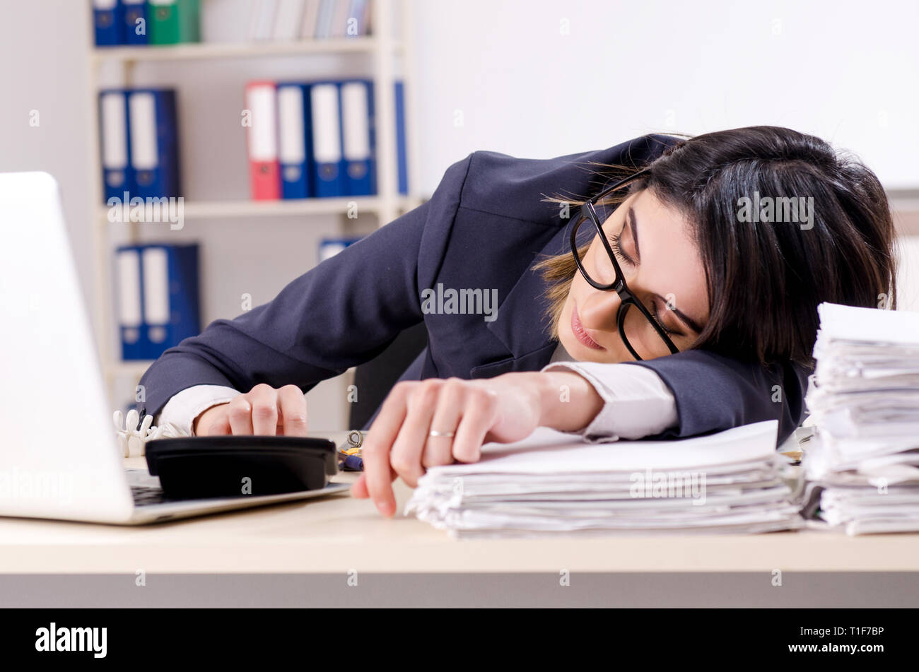 Young female employee sleeping in the office Stock Photo - Alamy