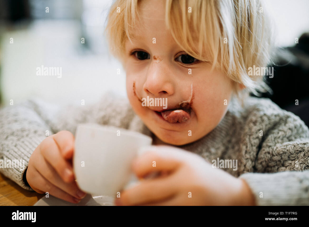 Boy drinking coffee Stock Photo - Alamy