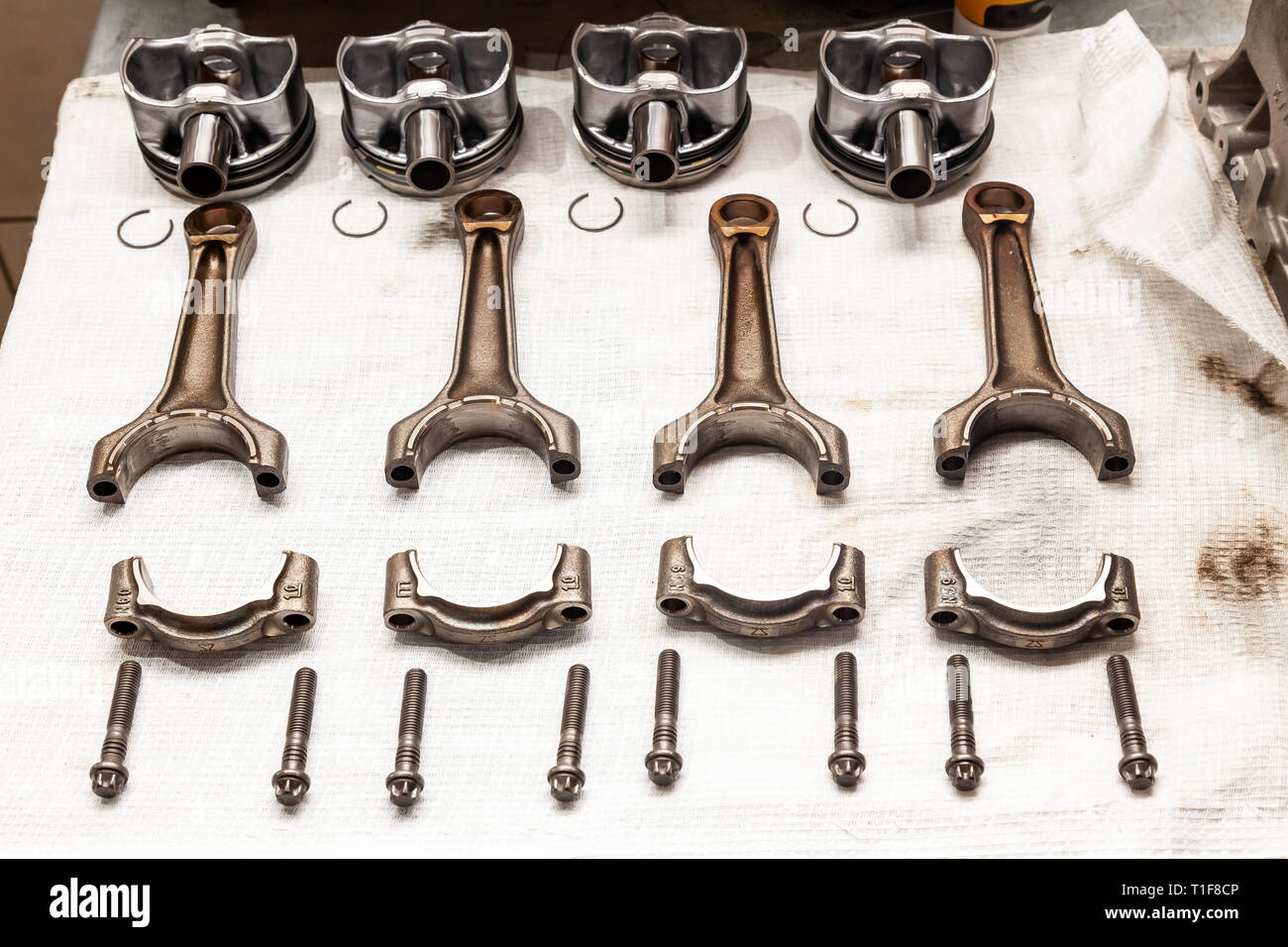 Engine connecting rods and pistons used and removed from a four ...