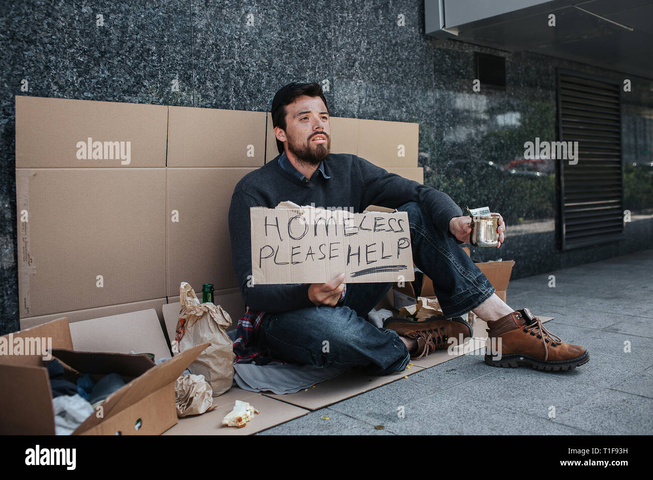 Homeless man holding cardboard sign hi-res stock photography and images ...