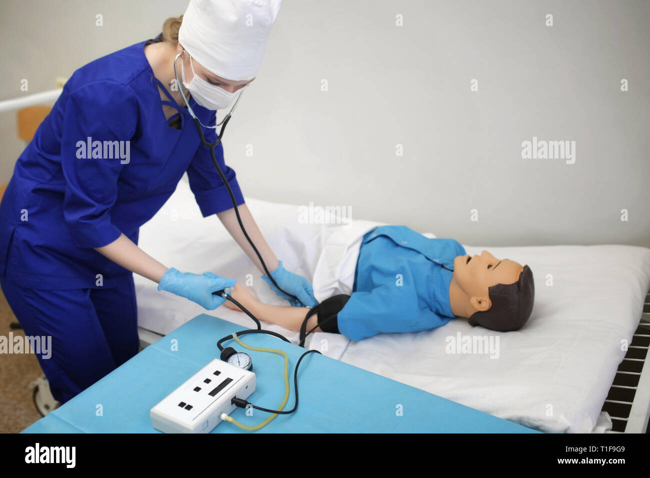 medical student measures the pressure on the dummy. Training in medical ...