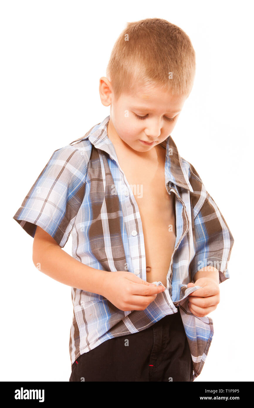 Childhood independence concept ,little boy buttoning on shirt ...