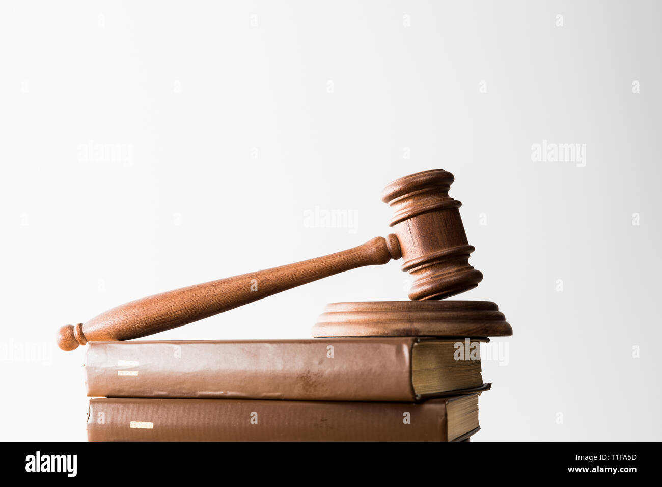 wooden gavel on pile of brown books isolated on white Stock Photo - Alamy