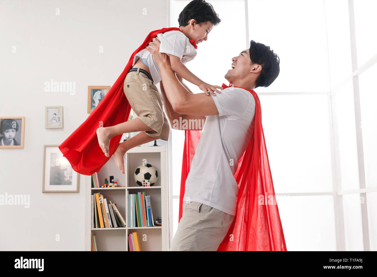Happy father and son playing a superman Stock Photo - Alamy