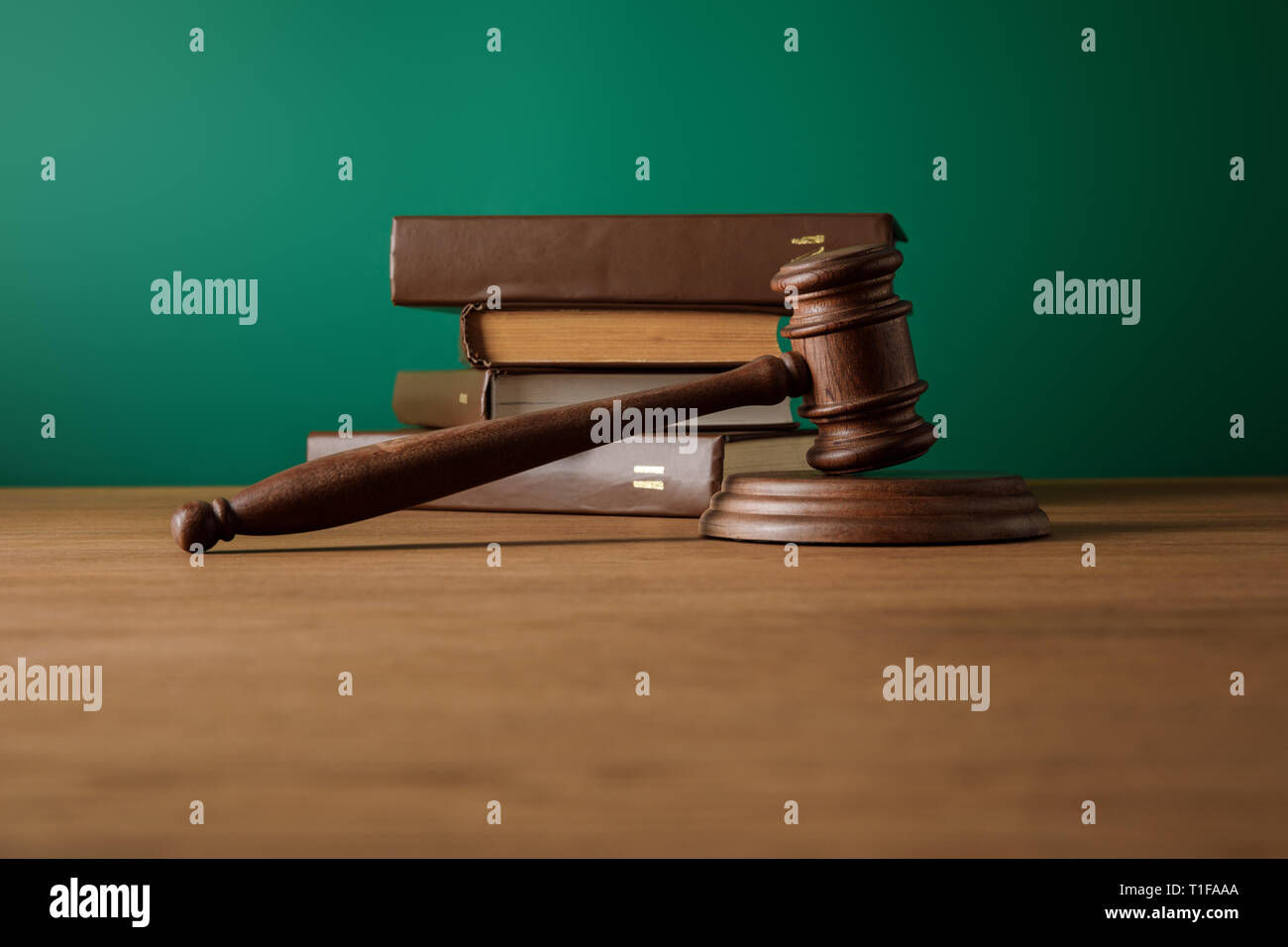 bottom view of volumes of brown books in leather covers and gavel on ...