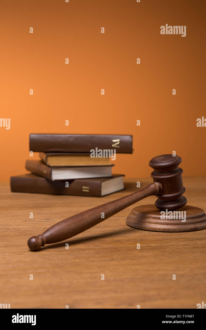 selective focus of volumes of brown books in leather covers and gavel ...
