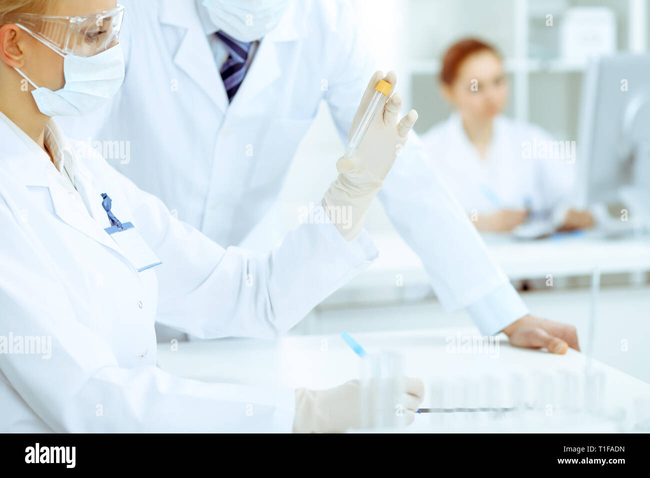 Scientific research team with clear solution in laboratory Stock Photo ...