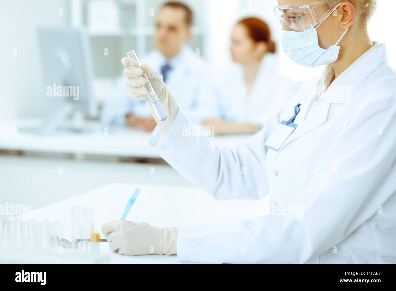 Scientific research team with clear solution in laboratory Stock Photo ...