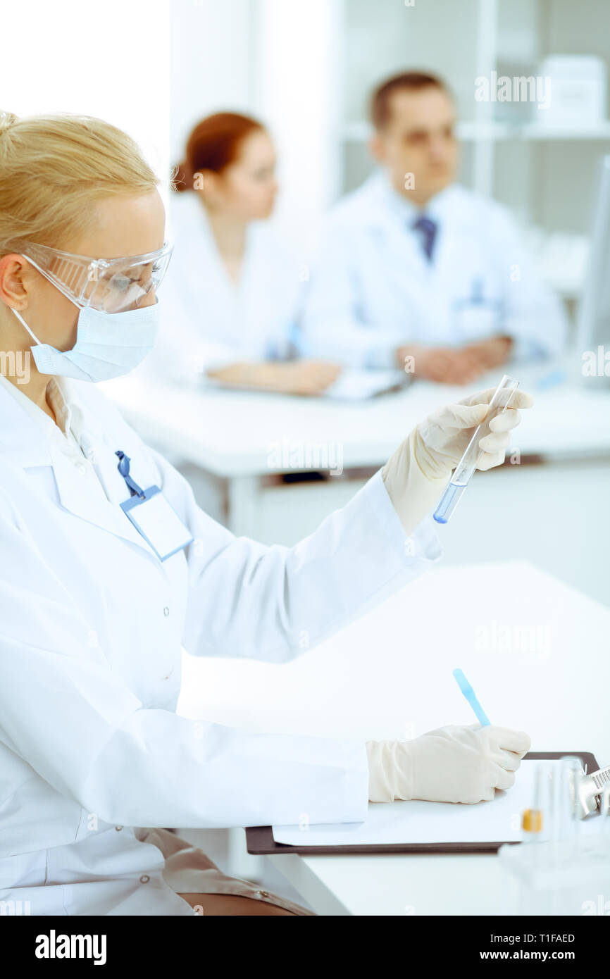 Scientific research team with clear solution in laboratory Stock Photo ...