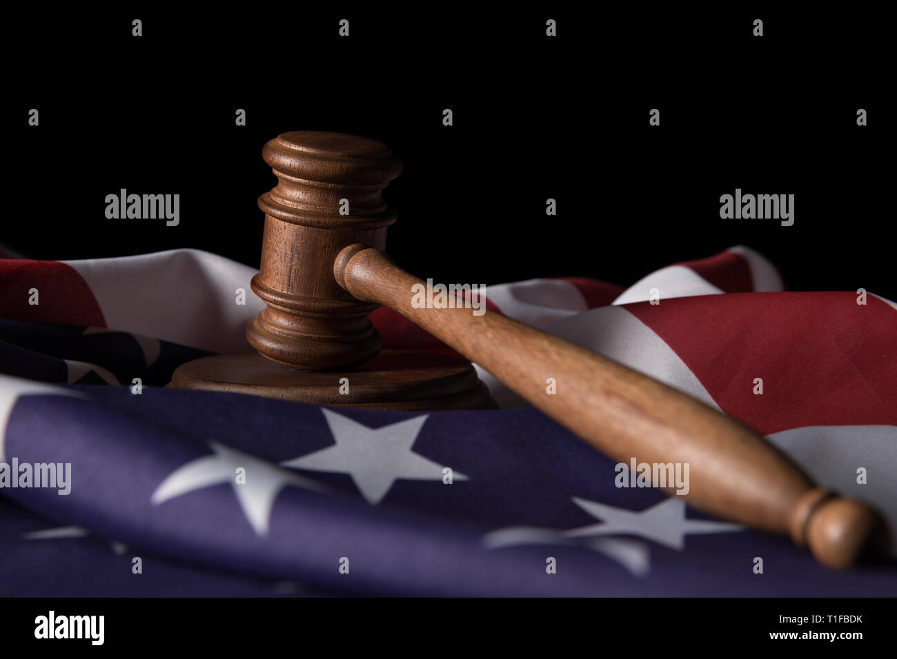 wooden gavel on american flag isolated on black Stock Photo - Alamy
