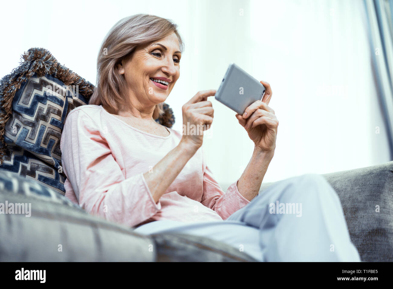 Beautiful Middle Aged Woman In Casual Clothes Is Making Selfie Stock