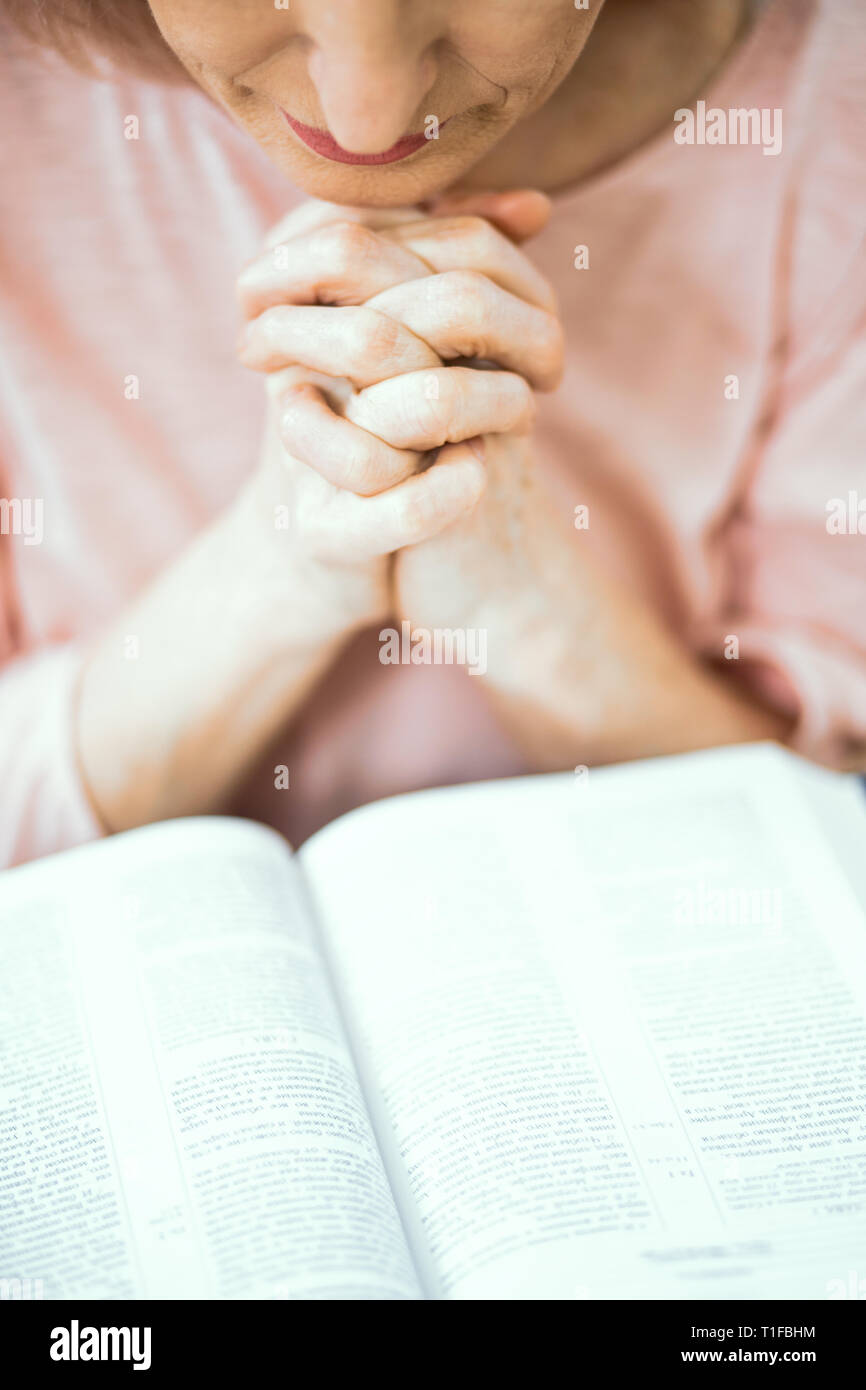 Old woman praying hi-res stock photography and images - Alamy