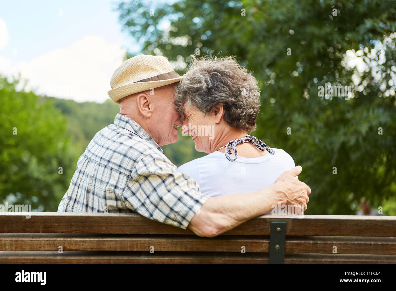 Senior couple hug bench hi-res stock photography and images - Alamy