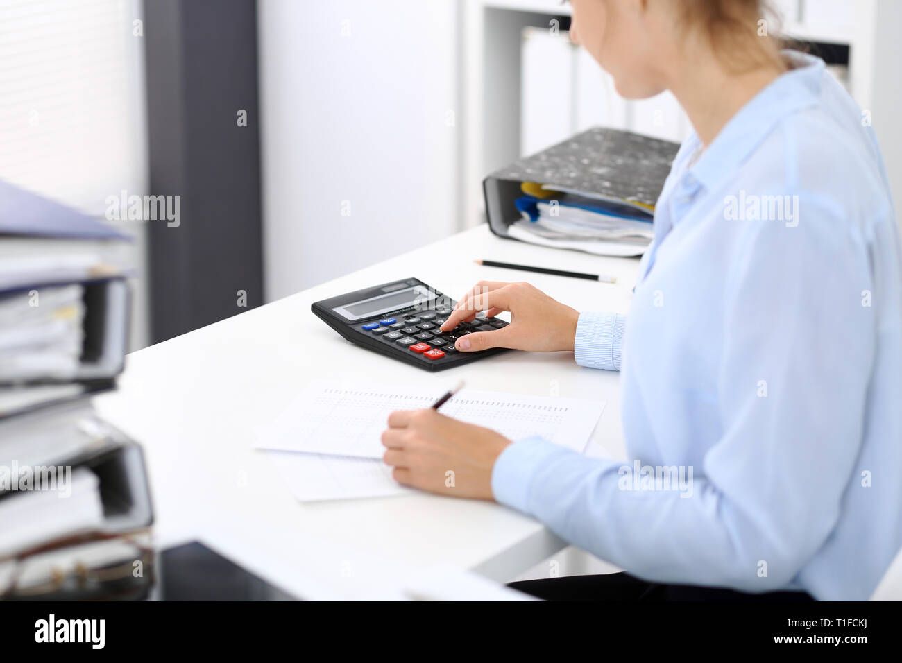 Unknown female bookkeeper or financial inspector calculating or ...