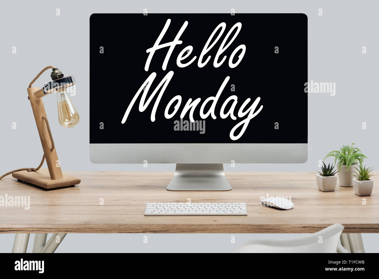 modern workplace with hello monday lettering on computer monitor at ...