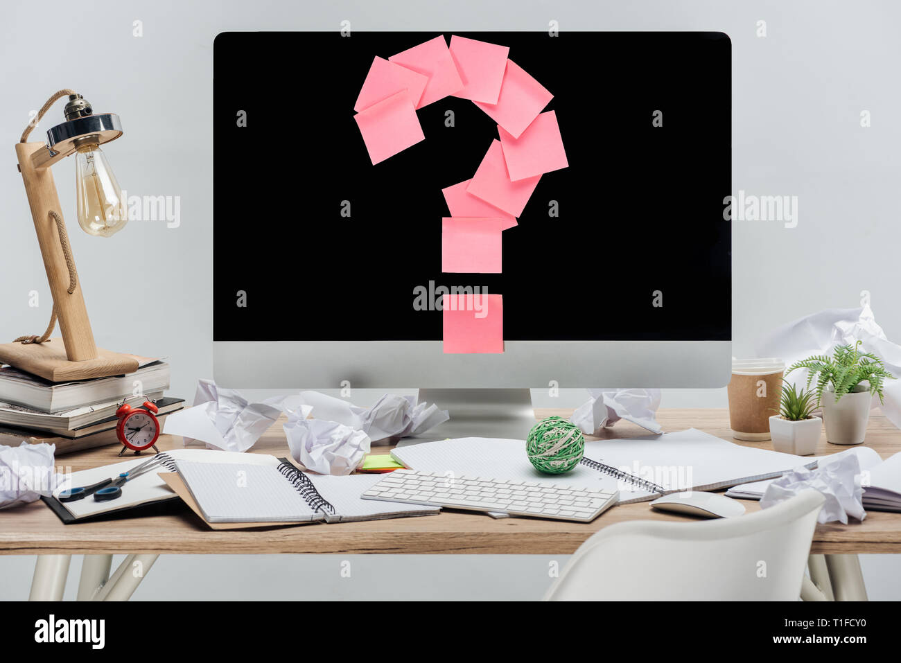 modern workplace with pink question mark made of sticky notes on ...