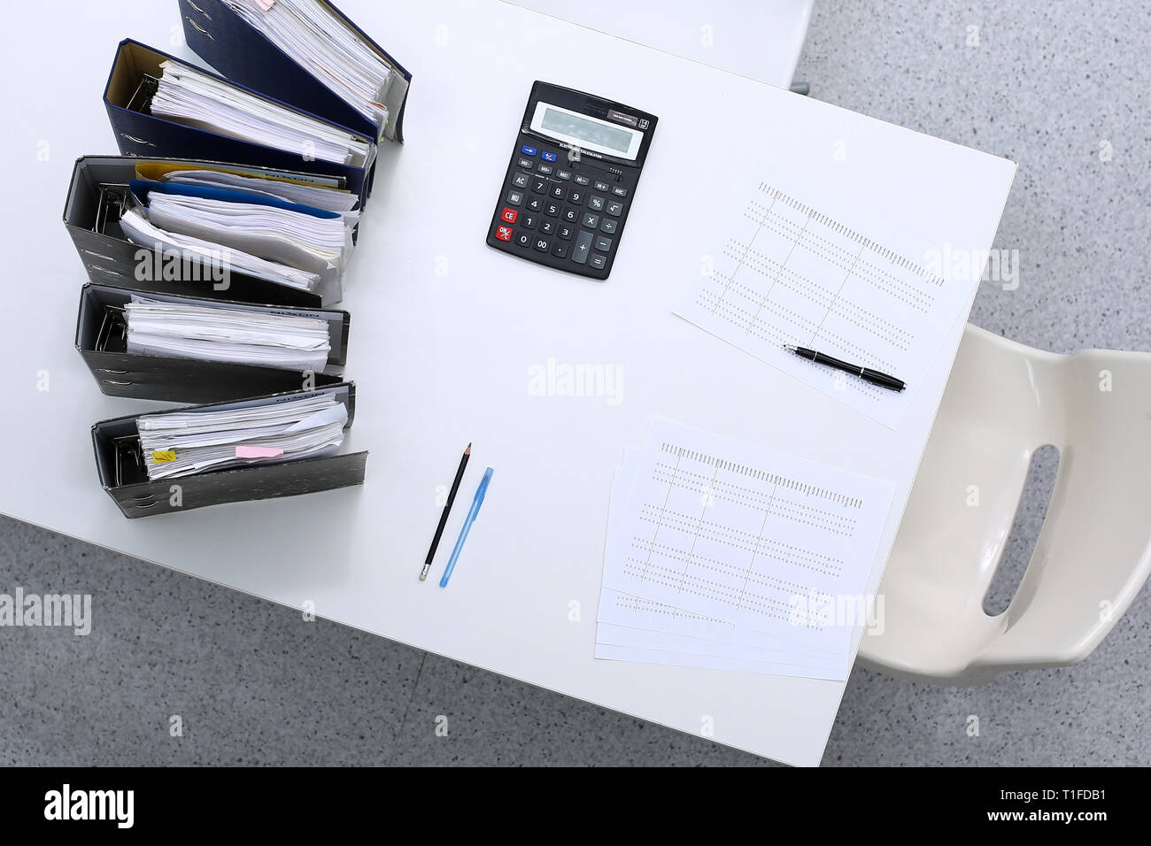 Binders with papers are waiting to be processed with bookkeeper ...