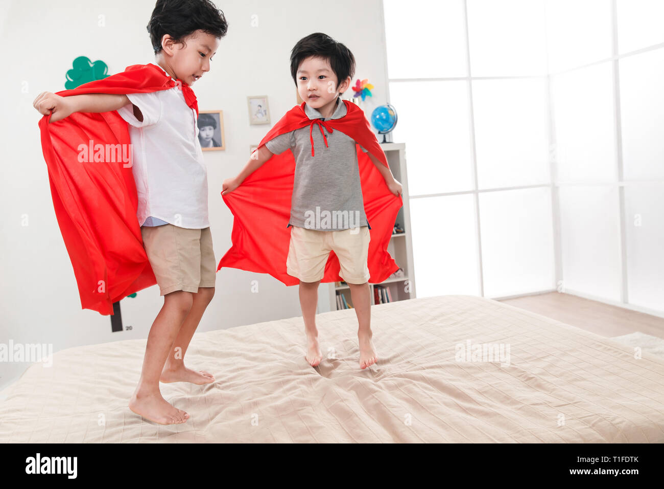 The two boys play superman Stock Photo - Alamy