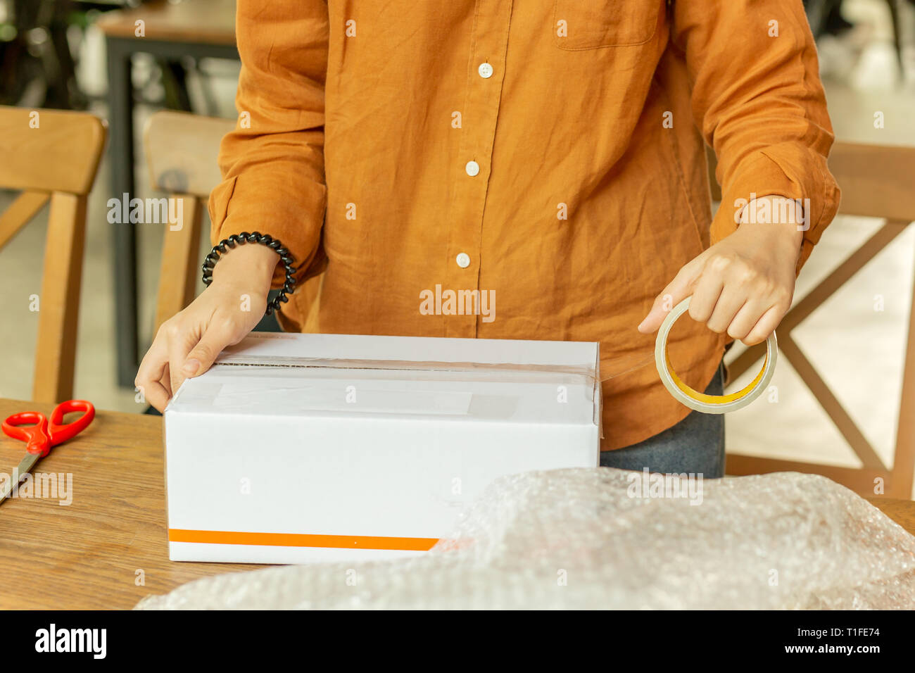Startup small business woman owner packing cardboard box at workplace ...