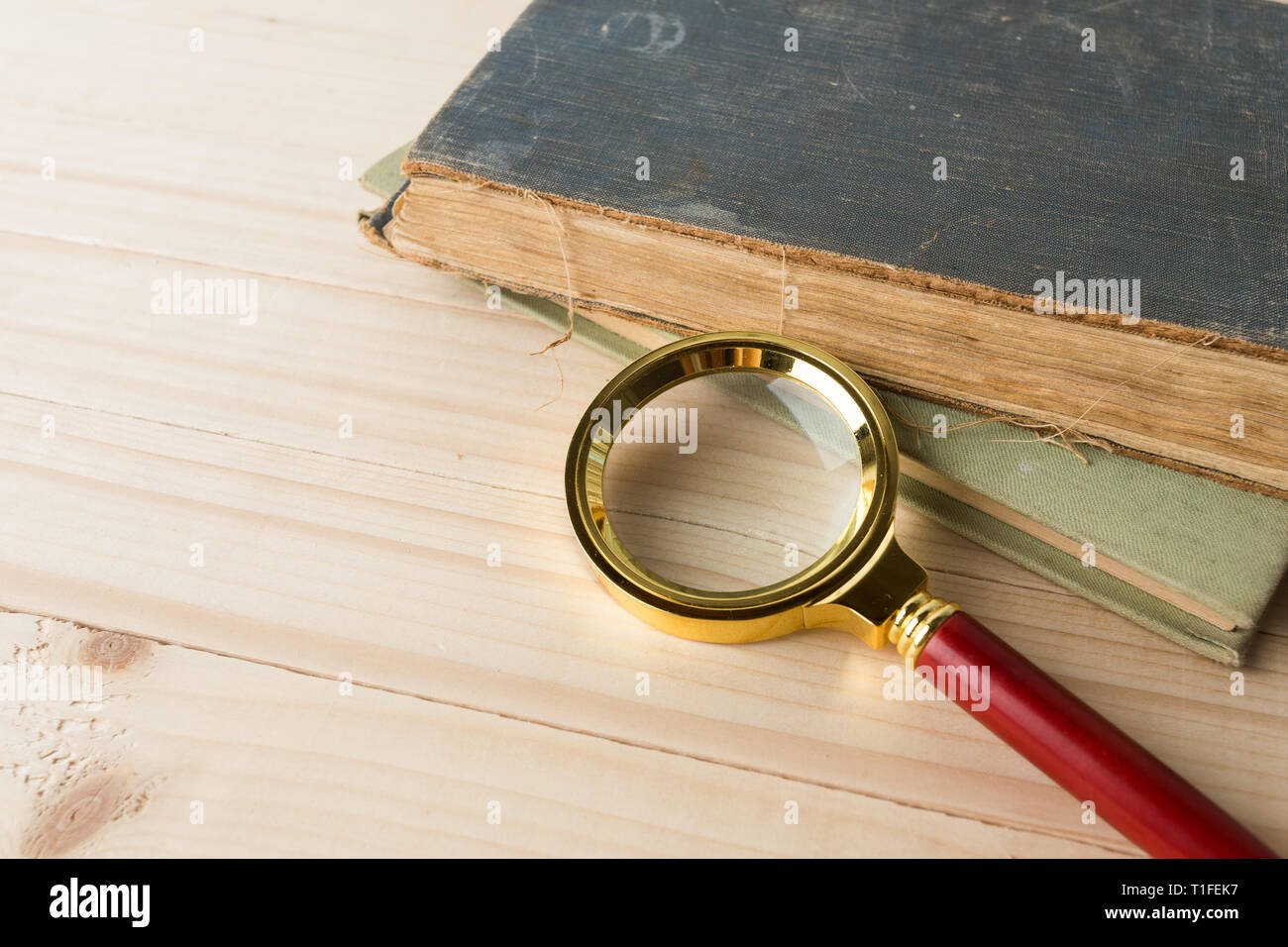 Magnifying glass and book Stock Photo - Alamy