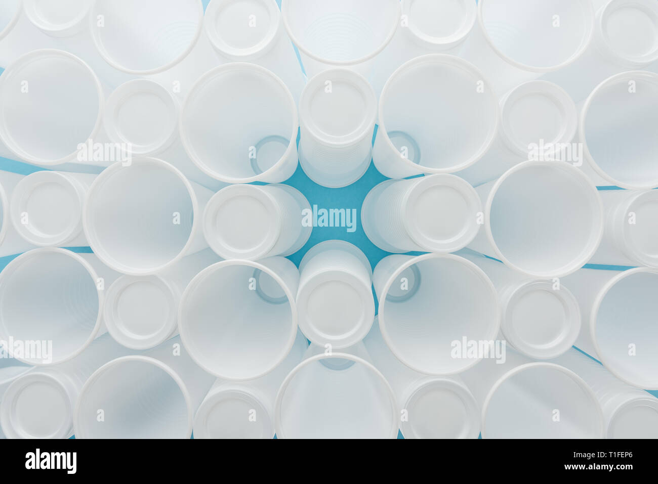top view of white plastic cups on blue background with copy space Stock ...