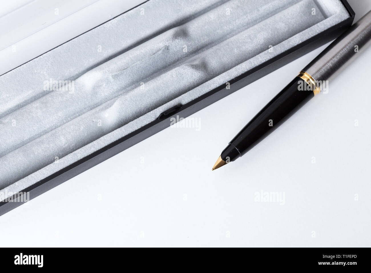 Pen in box on white background Stock Photo - Alamy