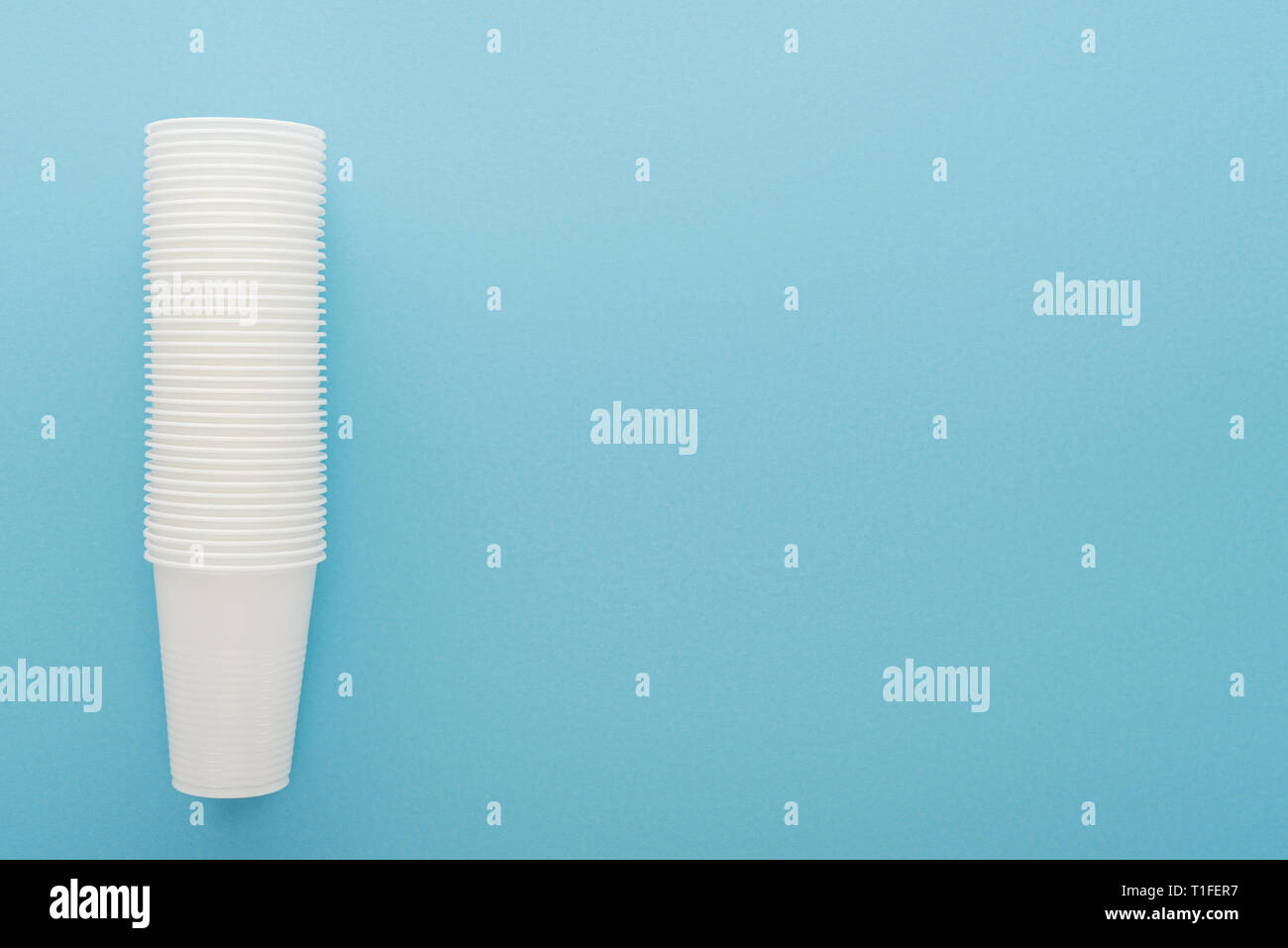top view of white plastic cups on blue background with copy space Stock ...