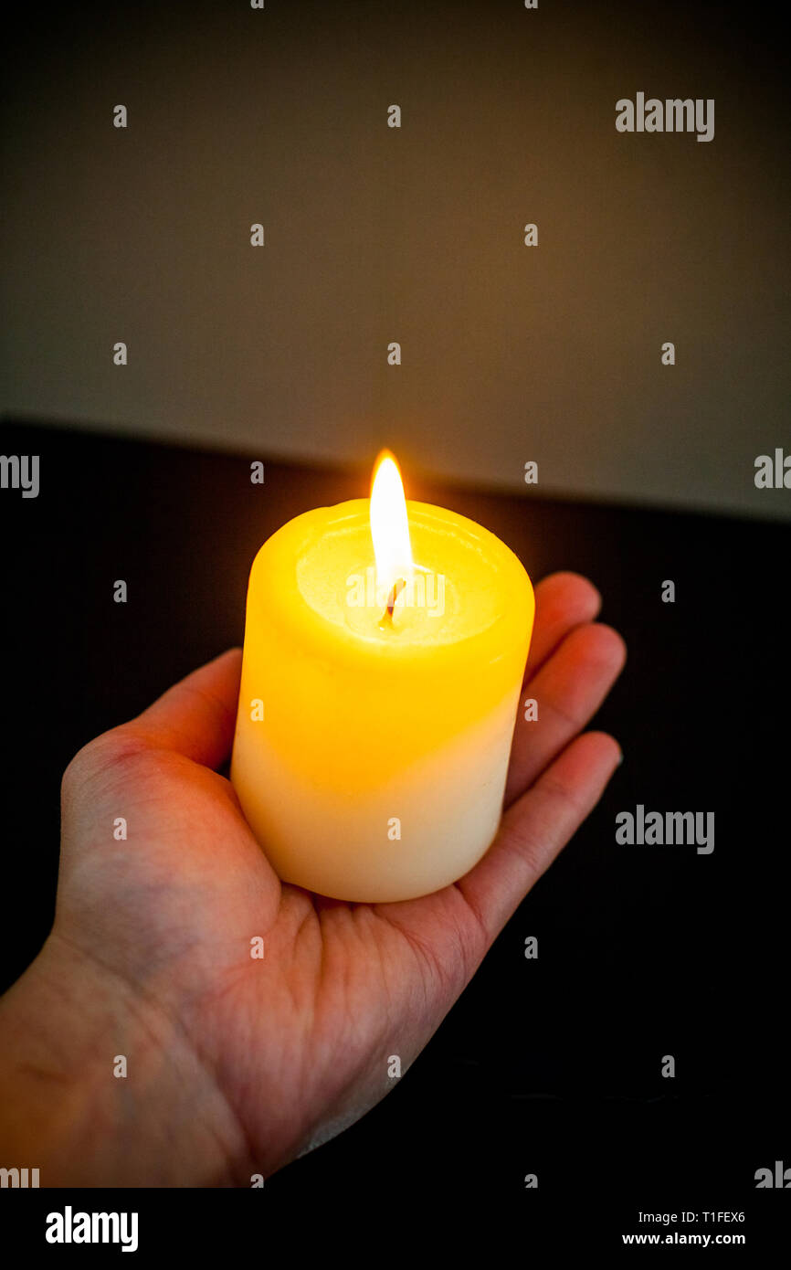 Candle in the hand Stock Photo - Alamy