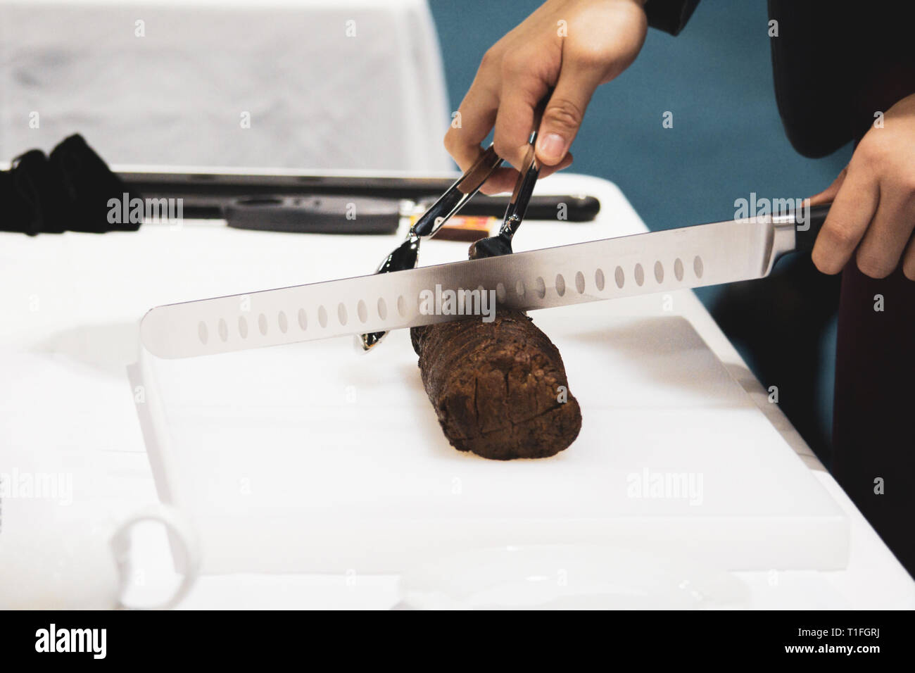 Roast beef and slice, chef's hands cutting roast beef, Carving roast ...