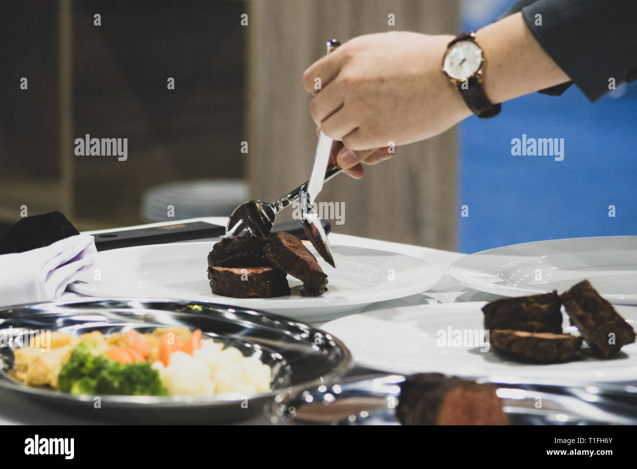 Decorating The Food In The Restaurant, Waiter is working on finishing a ...