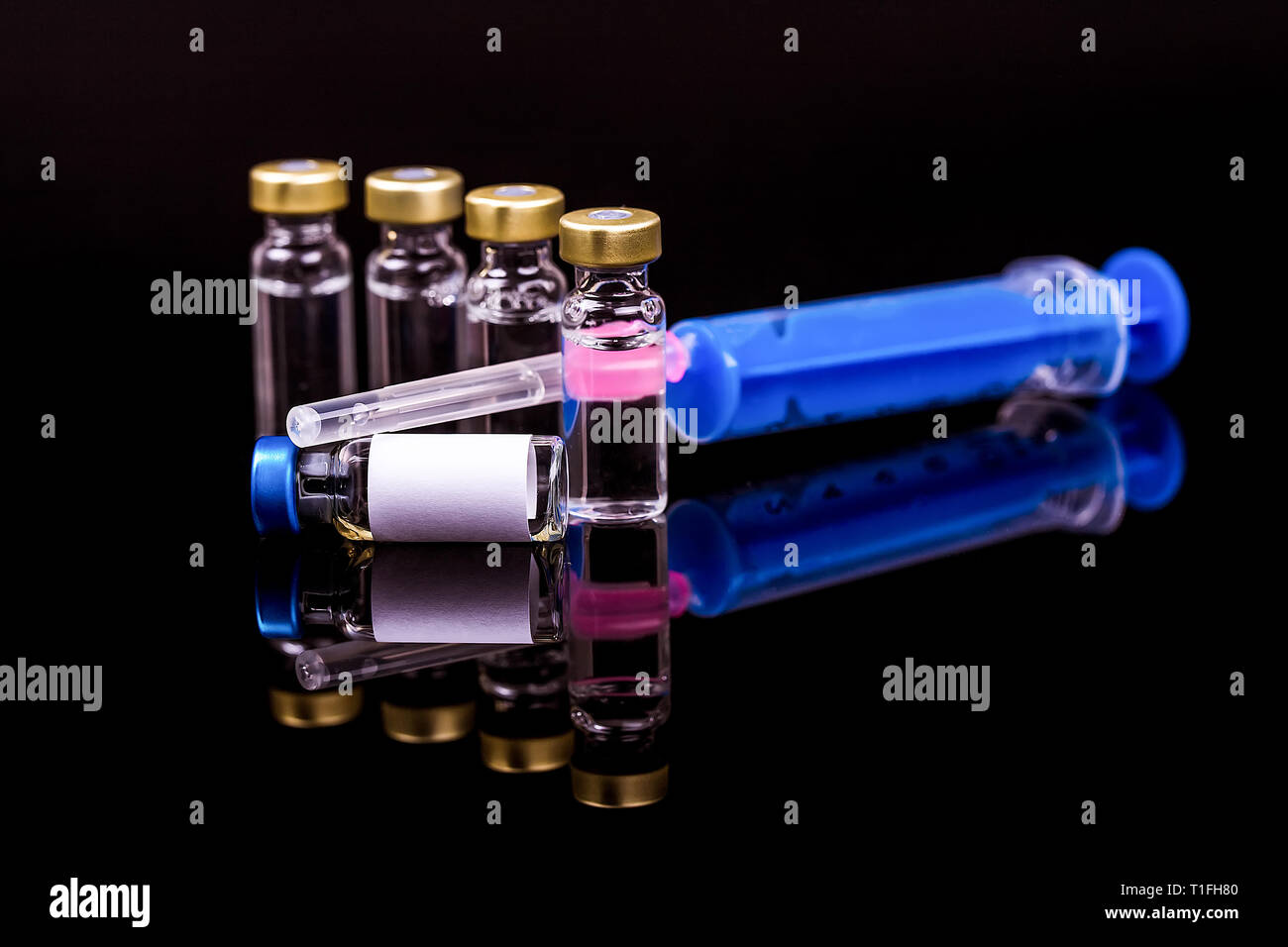 Medical vials for injection with a syringe and ampules on black ...