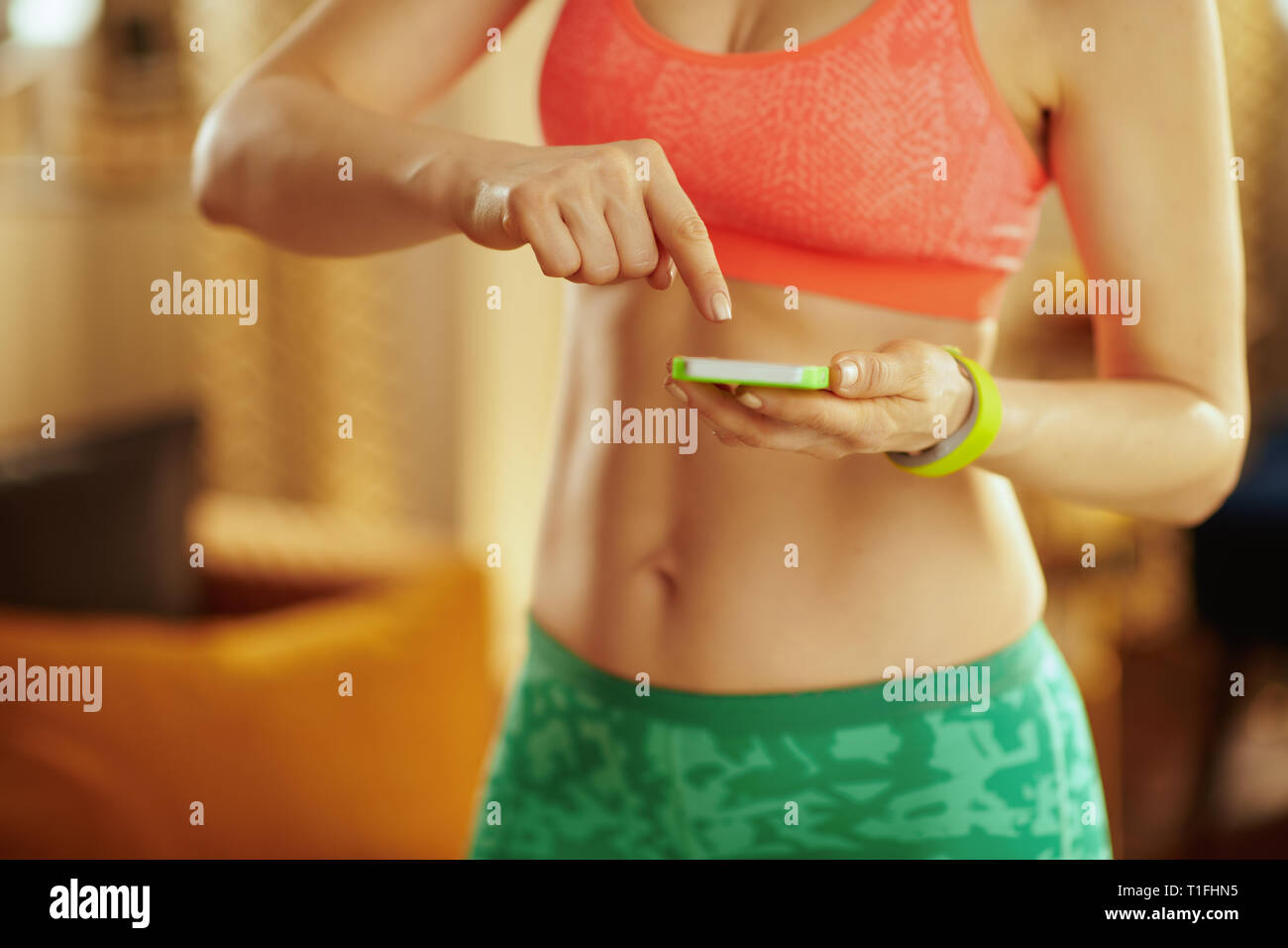 Closeup on smartphone in hand of fit woman using smartphone to track ...