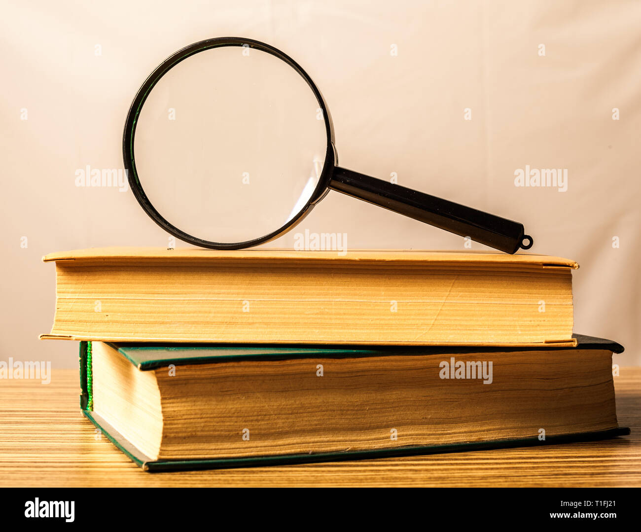 books and magnifying glass Stock Photo - Alamy