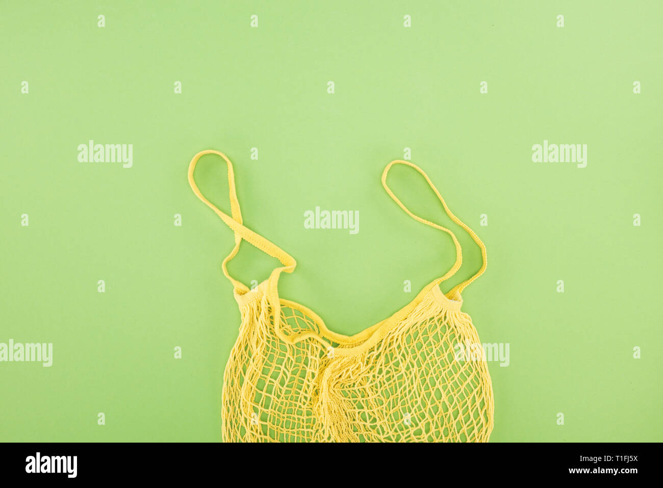 top view of yellow empty string bag on light green background Stock ...