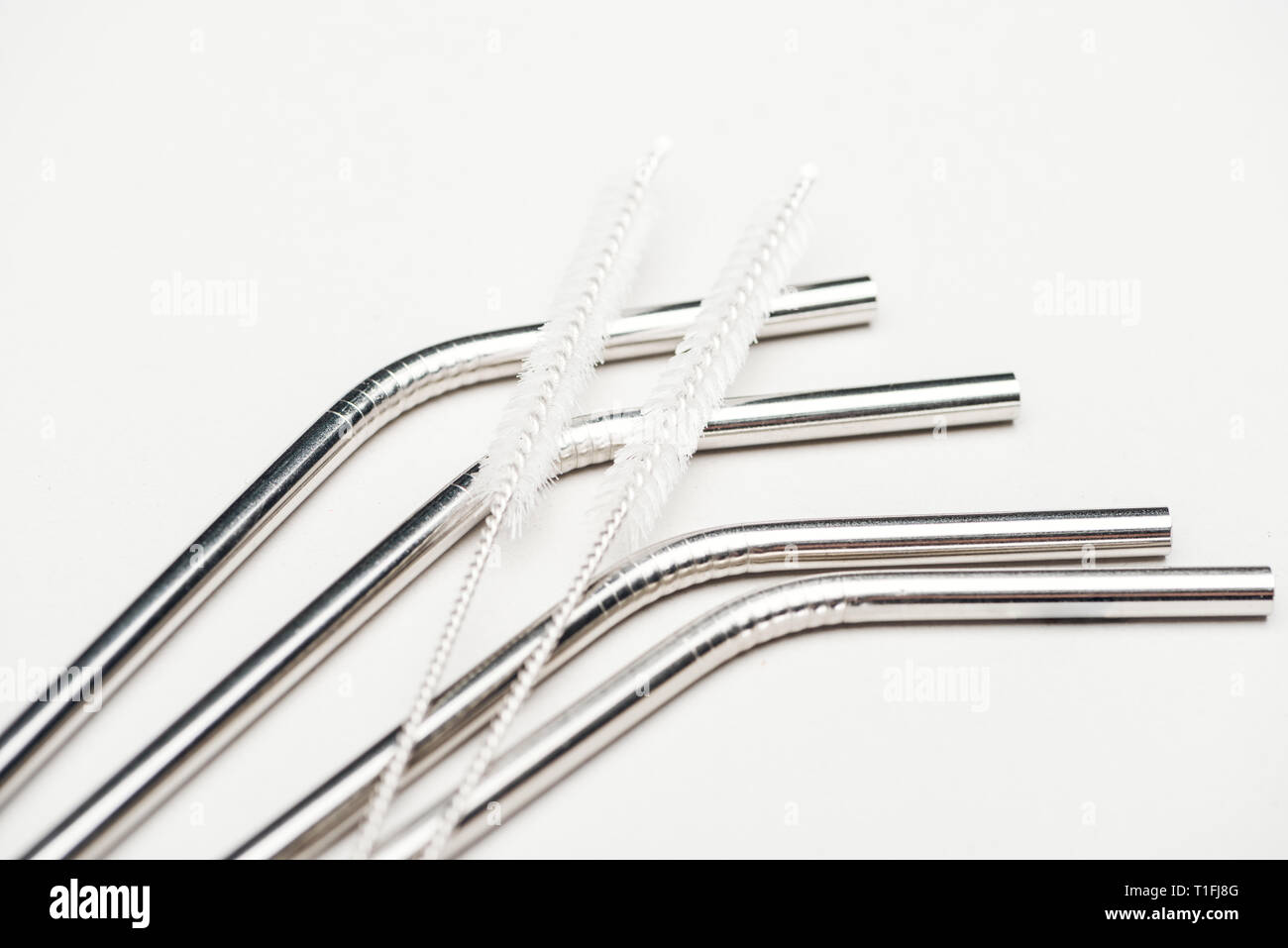 stainless steel straws and cleaning brushes isolated on grey Stock ...