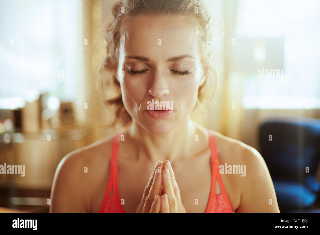 Portrait of relaxed young sports woman in fitness clothes at modern ...