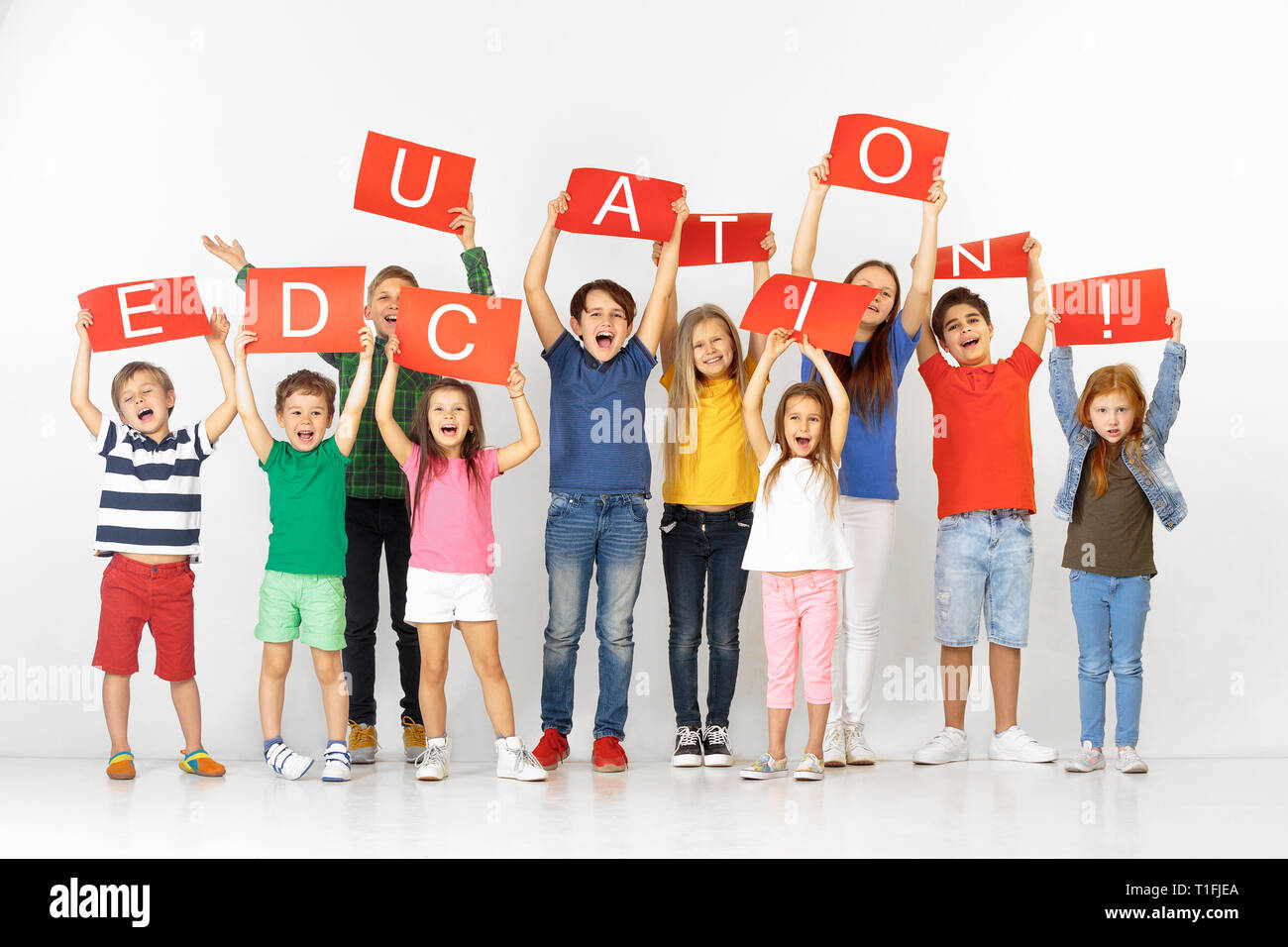 Education gives the way of life. Group of happy screaming children or ...