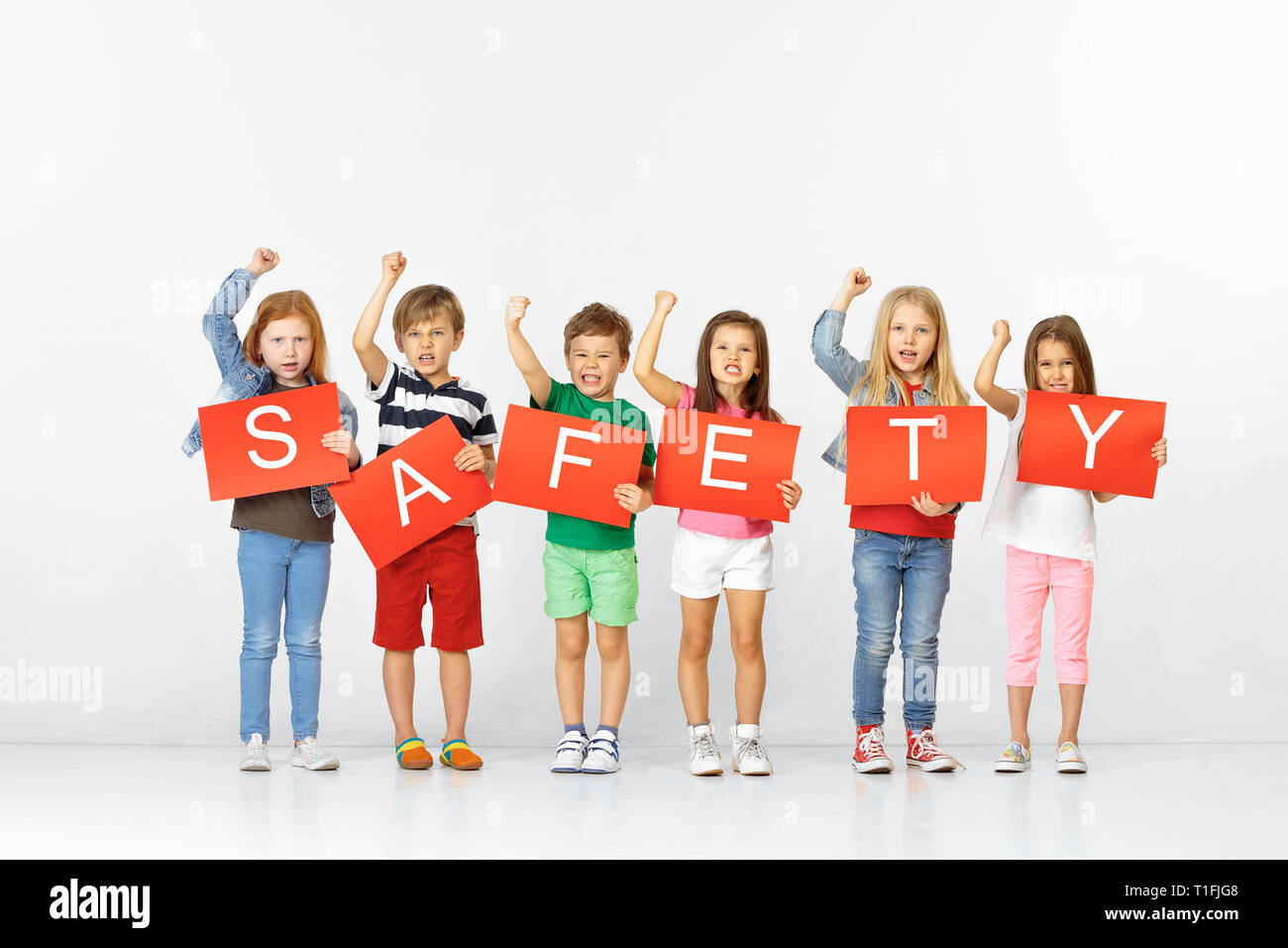 Safety feeling gives calm. Group of unhappy angry children with red ...