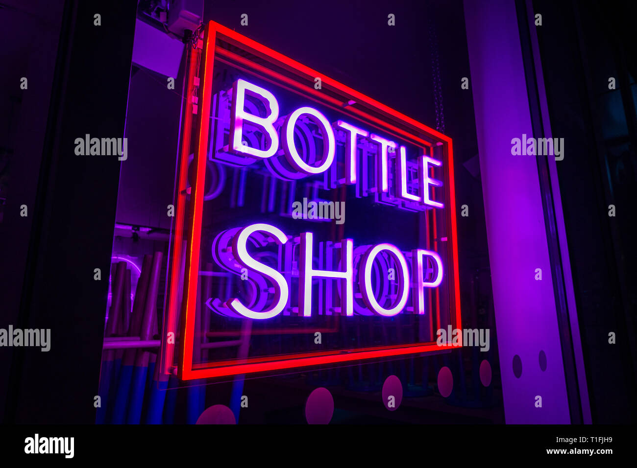 Bottle Shop square Neon Sign lit up in a restaurant near Granary Square ...