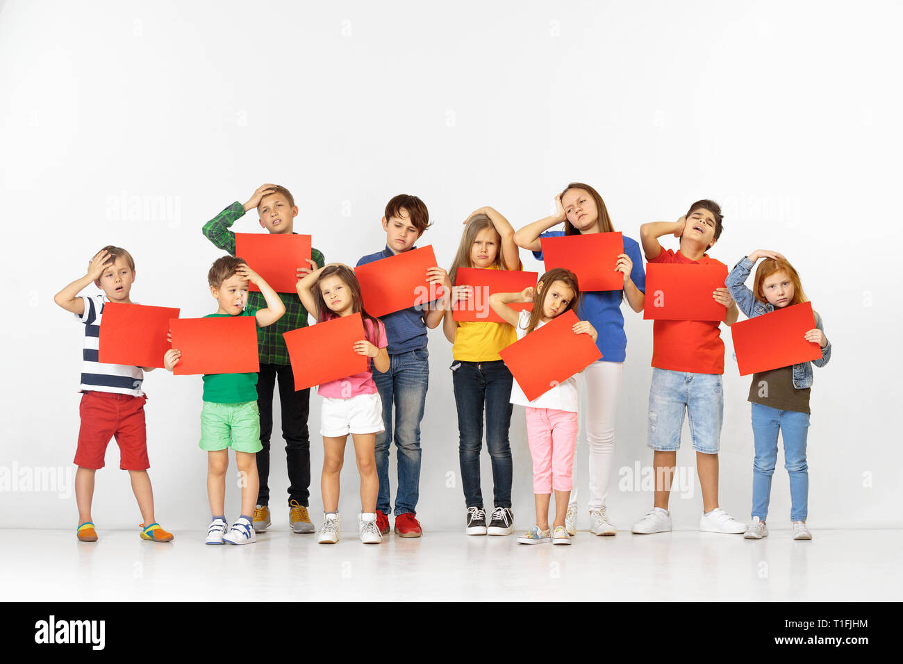 Group of saddened and distressed children with red empty banners ...