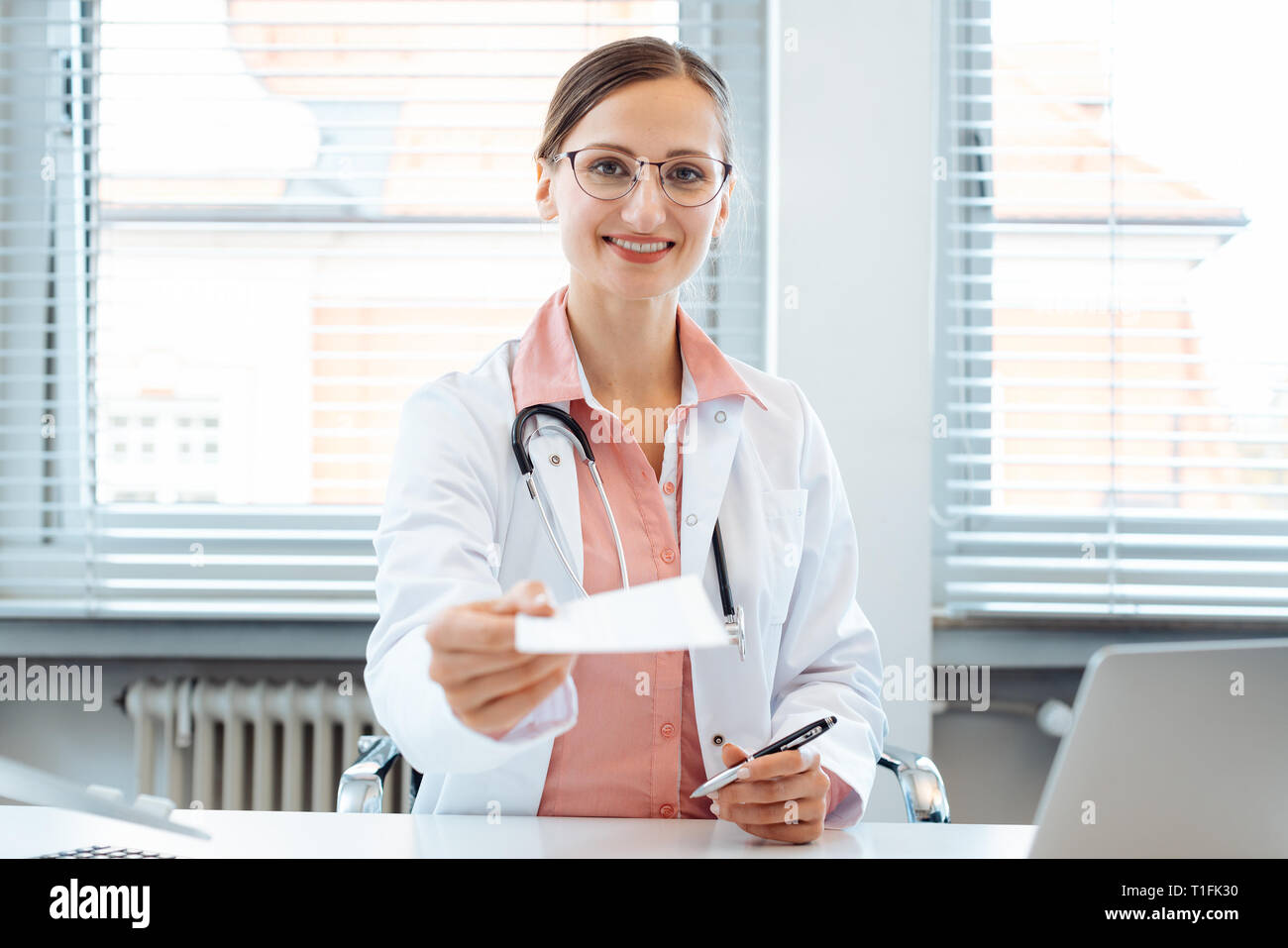 Doctor holding prescription paper into the camera Stock Photo - Alamy