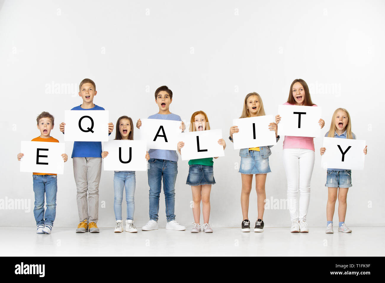 Equality gives us friendship. Group of smiling and screaming children ...