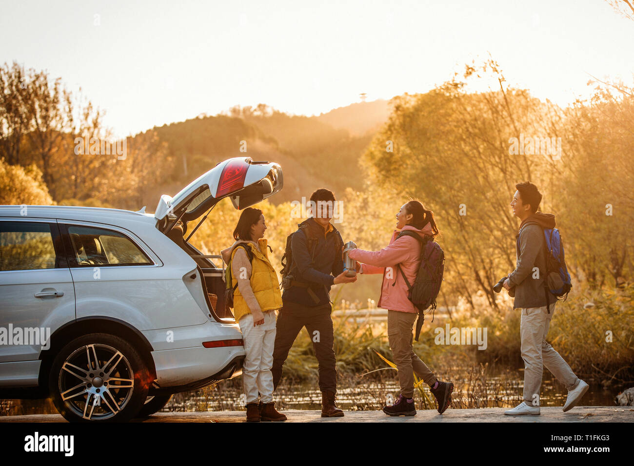 Young men and women outdoor outing Stock Photo - Alamy