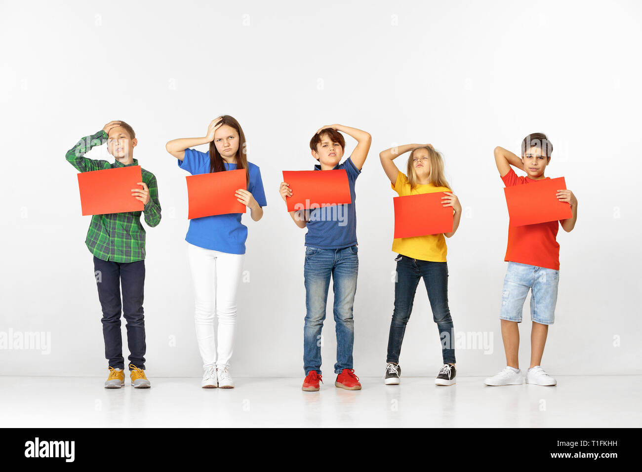 Group of saddened and distressed children with red empty banners ...